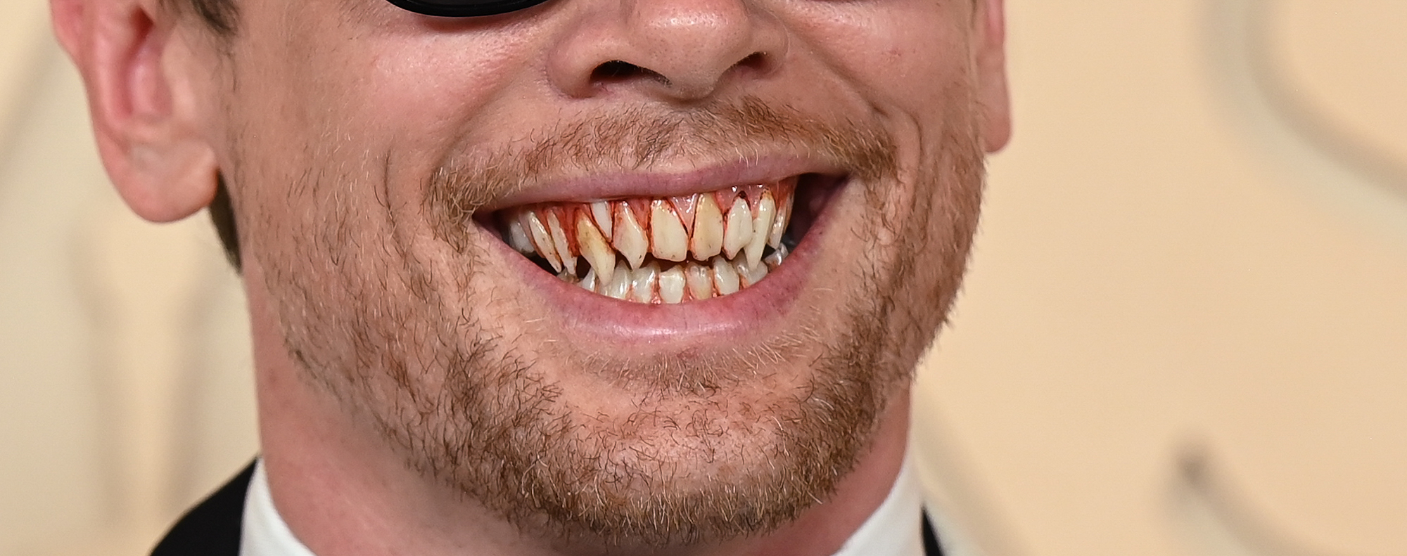 Actor Flashes Vampire Fangs on Oscars Red Carpet - PopCulture.com