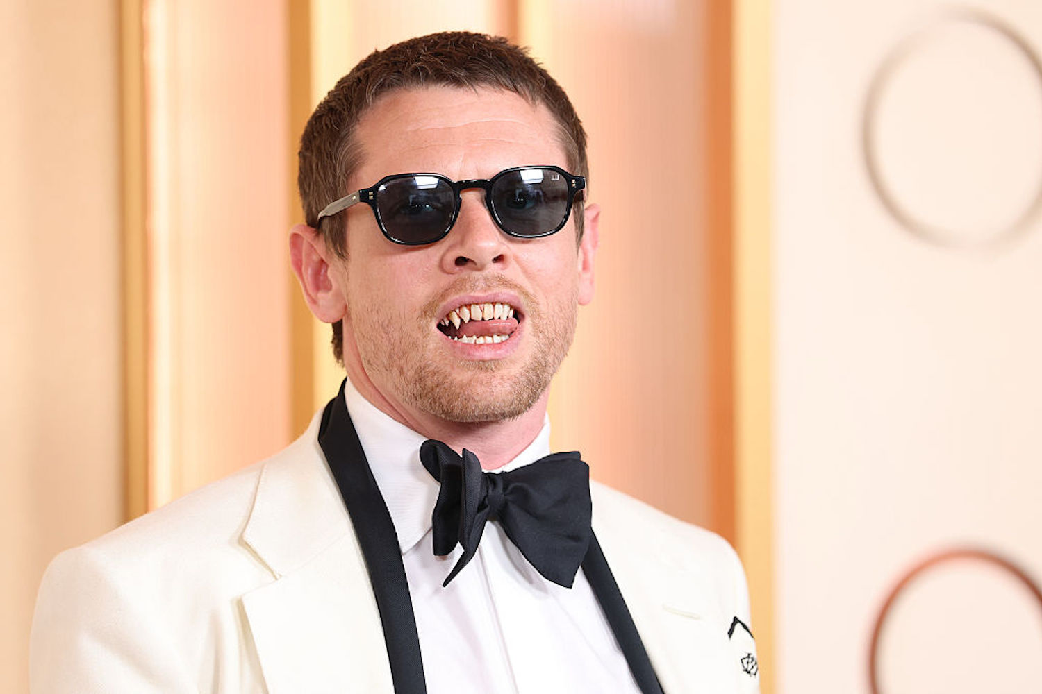 Actor Flashes Vampire Fangs on Oscars Red Carpet - PopCulture.com